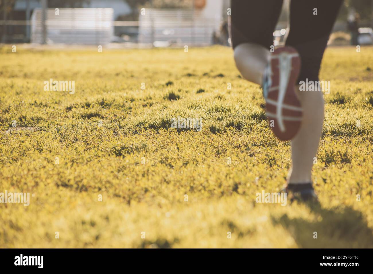 A view of a person running on a grass field Stock Photo - Alamy