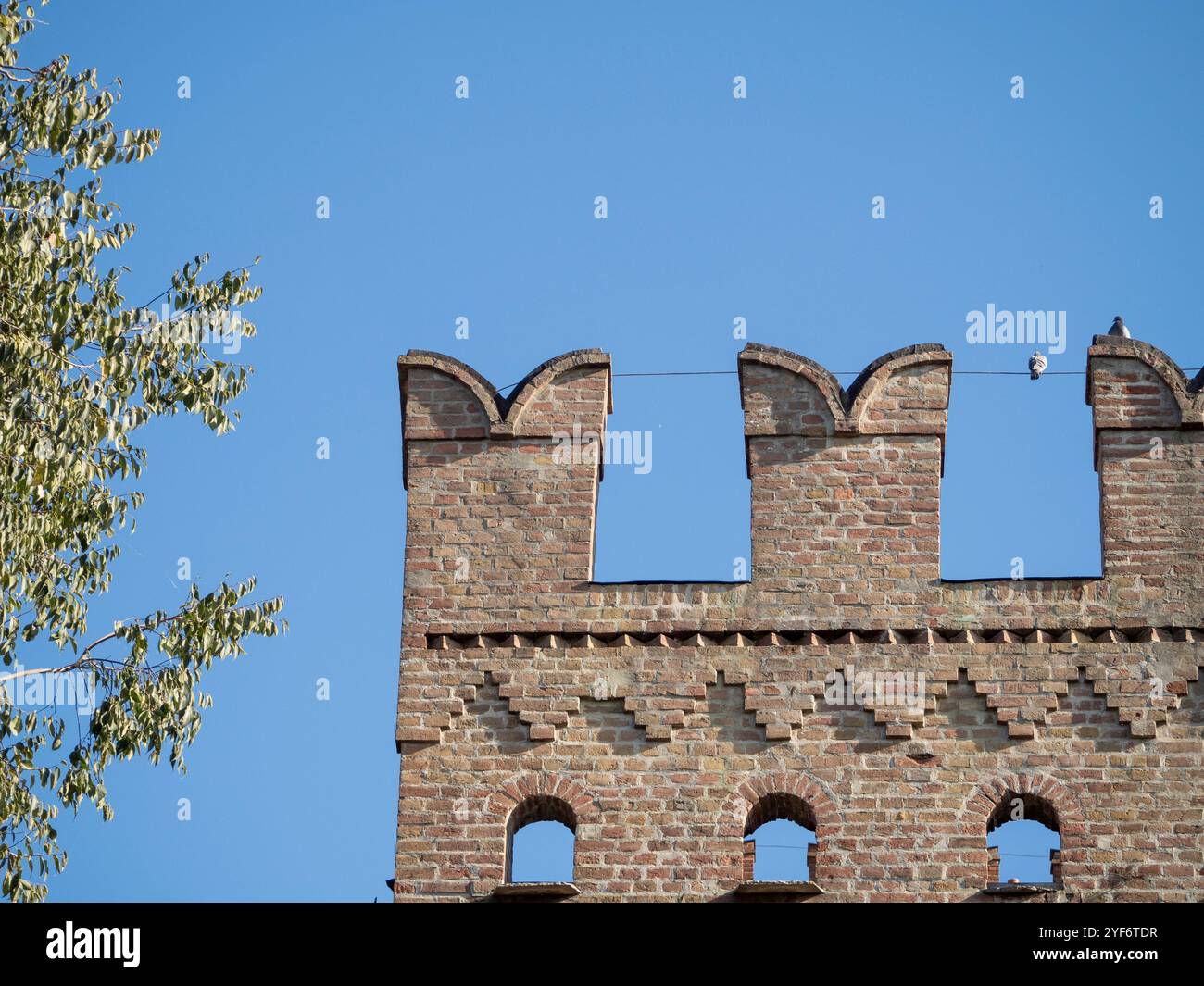 Busseto,Parma, Italy - November 3rd 2024 Brick merlons rising towards a ...