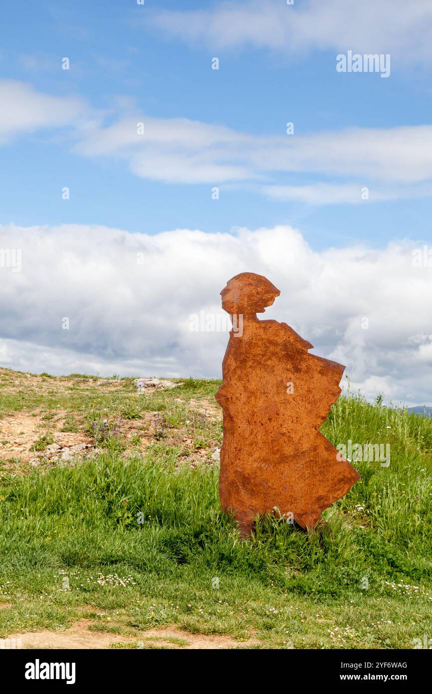 On the Camino de Santiago, metal sculptures of a pilgrim walking toward ...