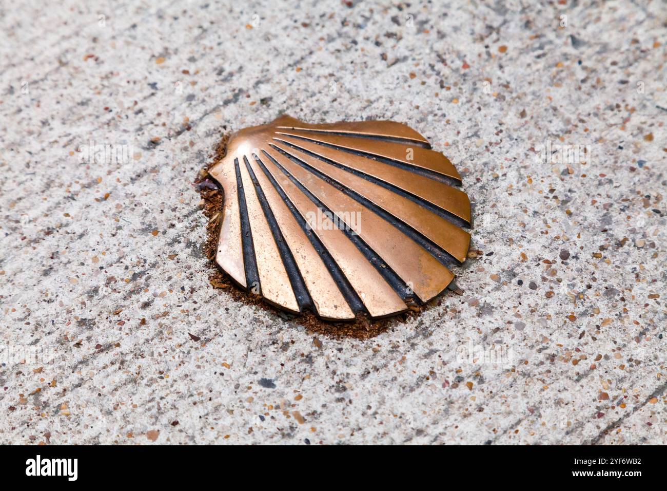 This bronze shell is set into a stone pathway, marking a trail at a ...
