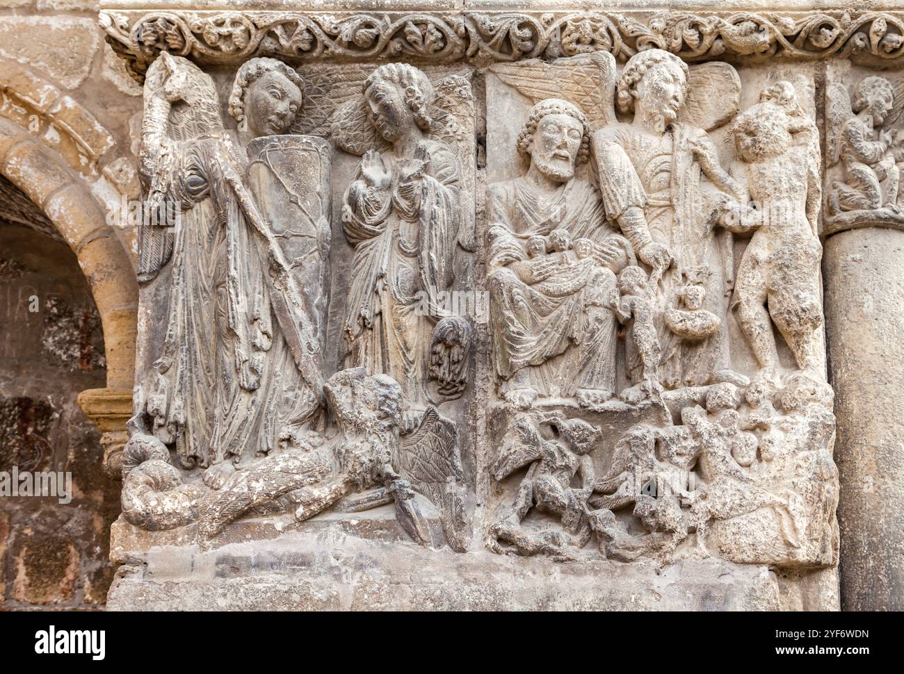 A detailed relief sculpture showcases biblical figures and scenes ...