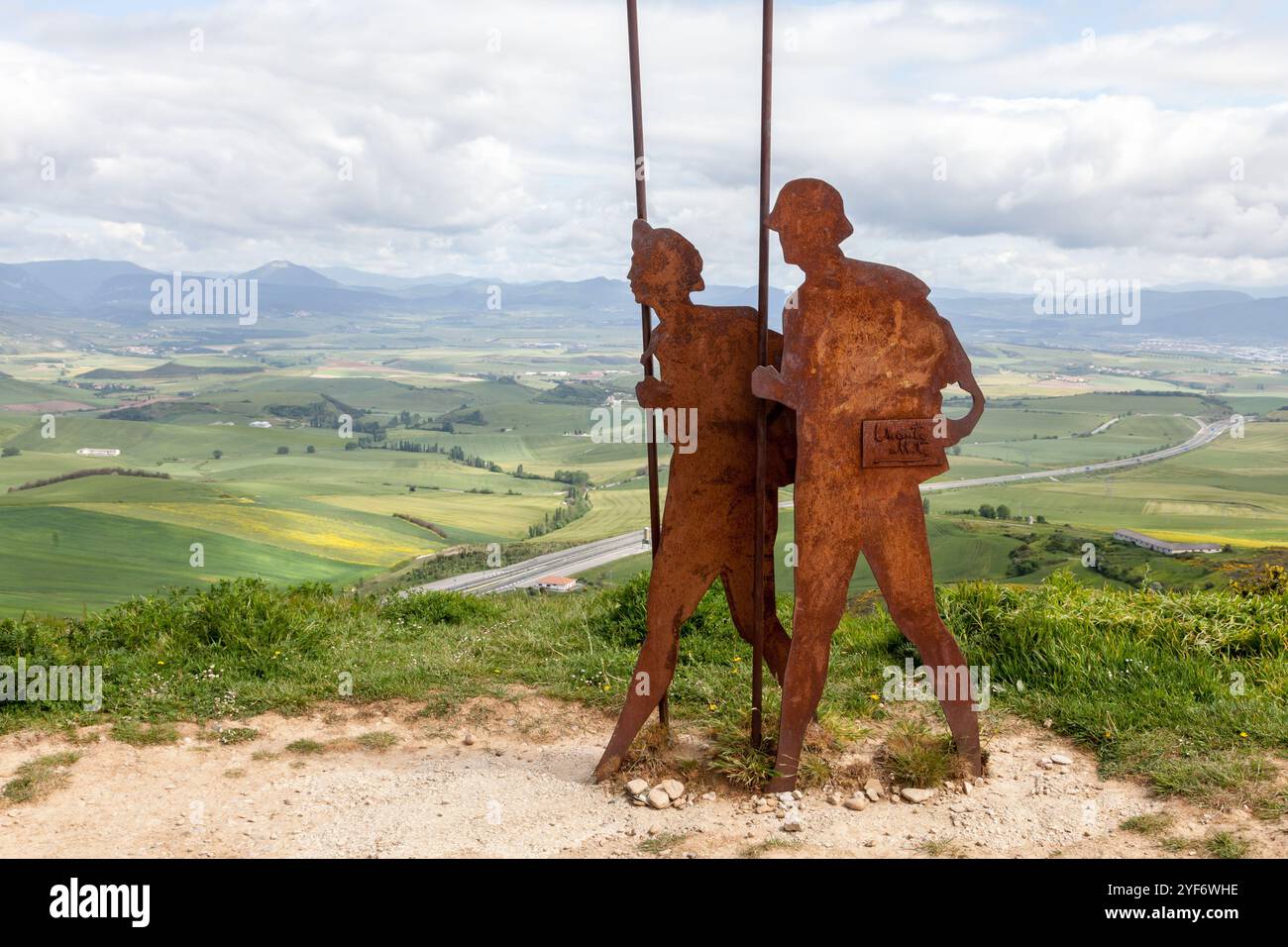 On the Camino de Santiago, metal sculptures of pilgrims walk toward ...