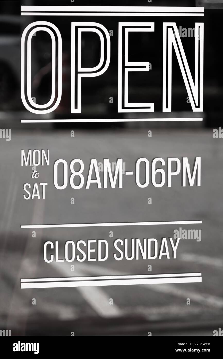 Business Hours Sign Storefront. Business hours sign on a glass door ...