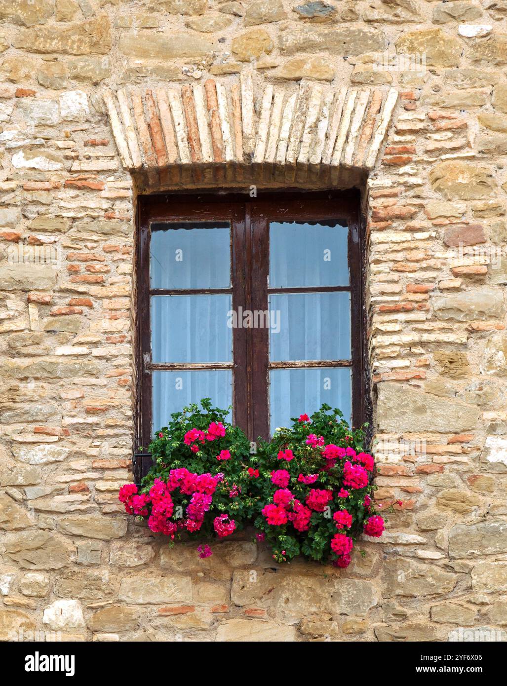 A rustic building features a wooden window with open shutters and a ...