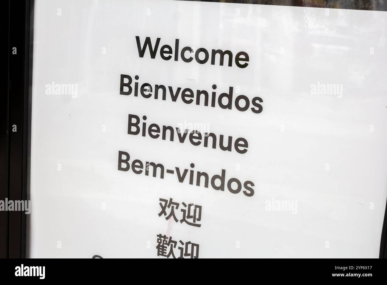 A view of a sign that says welcome in different language around the ...