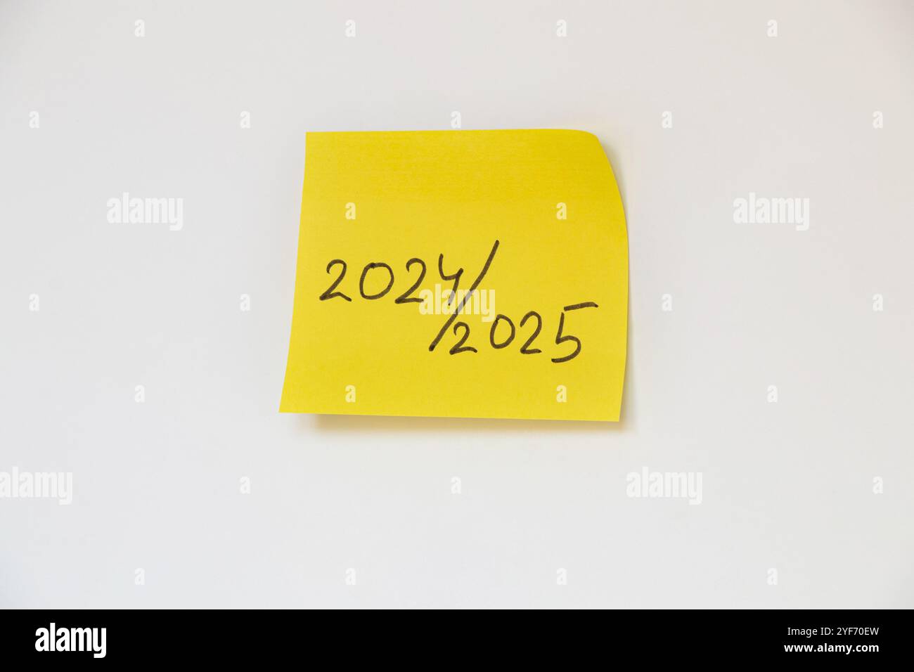 2024 and 2025 written on yellow paper which is glued to a white ...