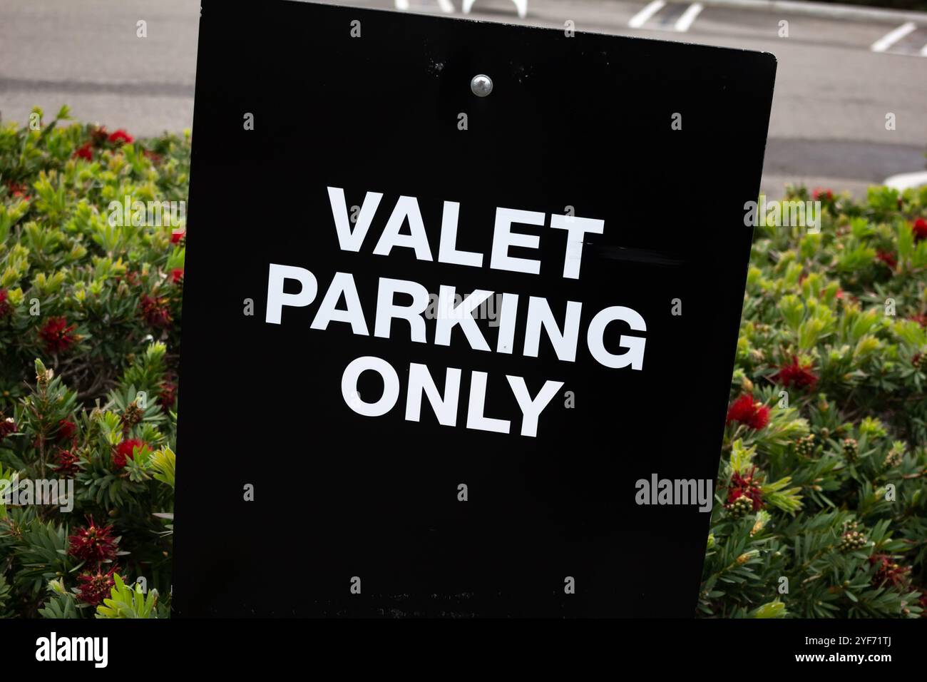 A view of a traffic sign directing cars that this area is for valet ...