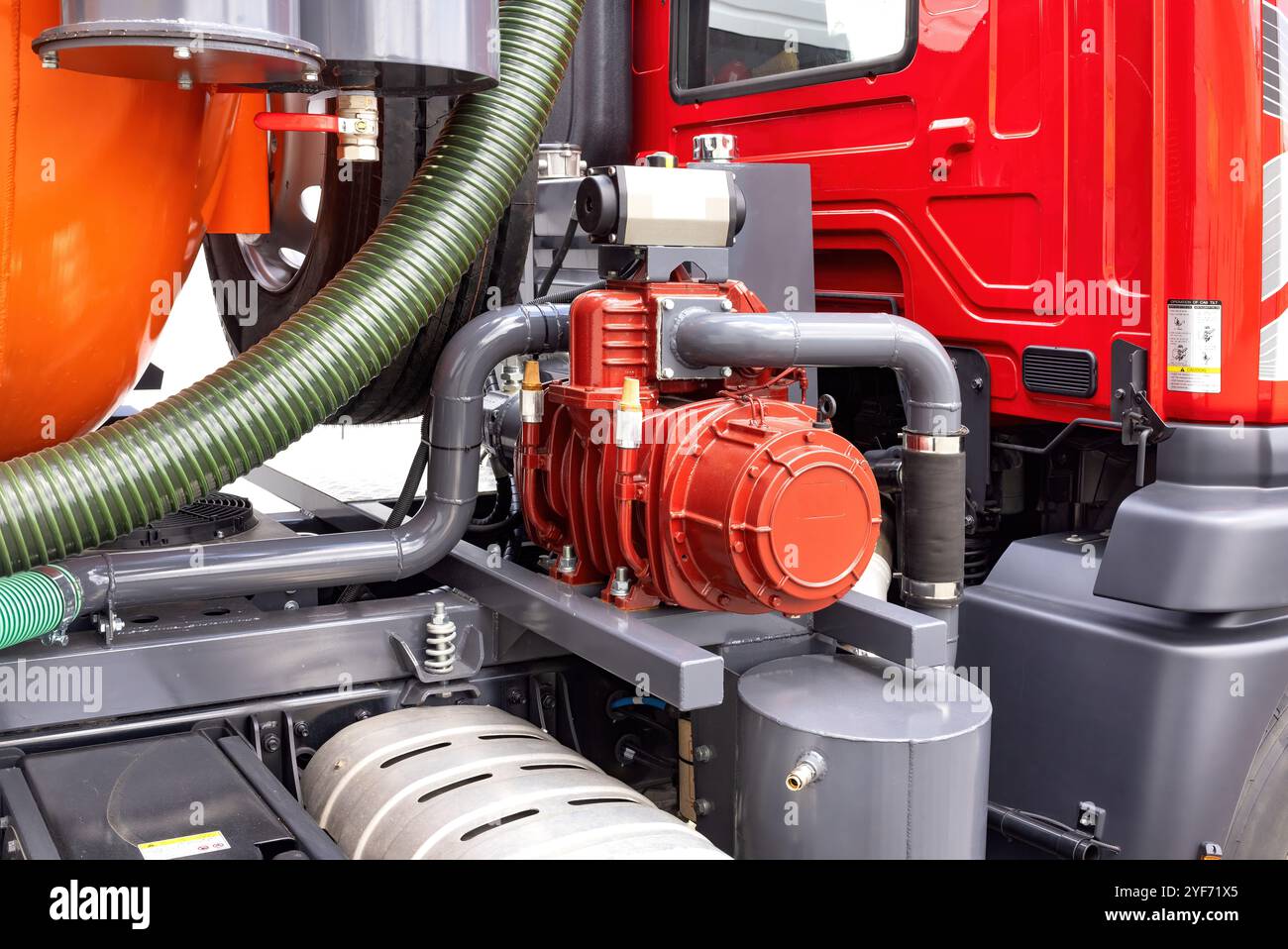 Vibrant red industrial machinery equipment with focus on hydraulic pump ...