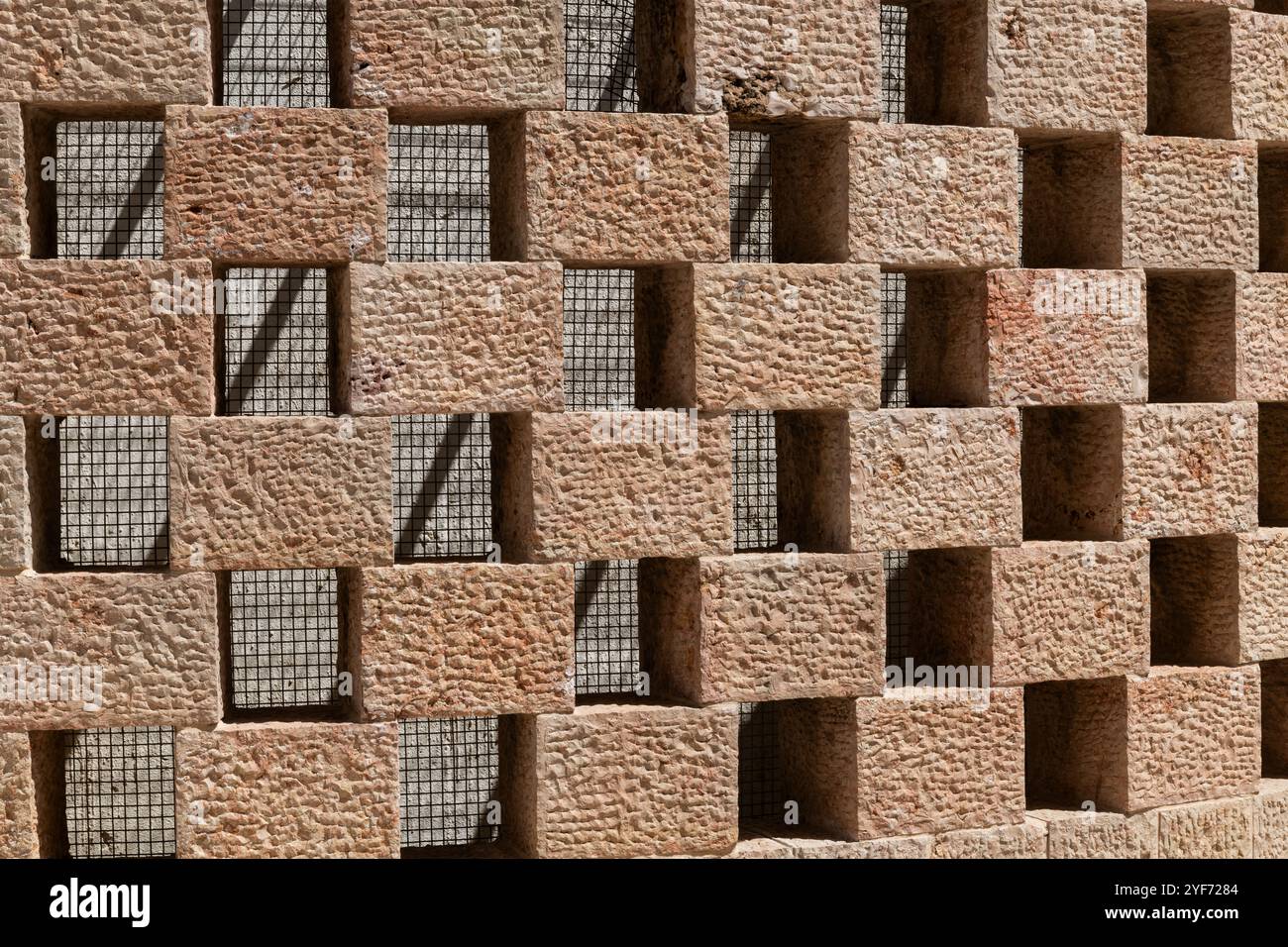 Abstract detail of shadow and sunlight on a stone wall with alternating ...