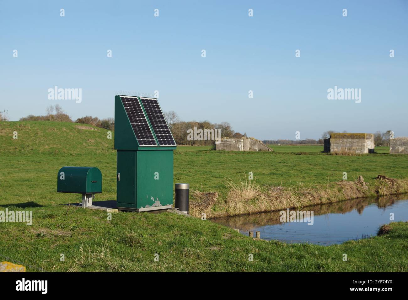 Small Dutch weir (Dutch: valve weir) with solar panels near a ditch. It ...