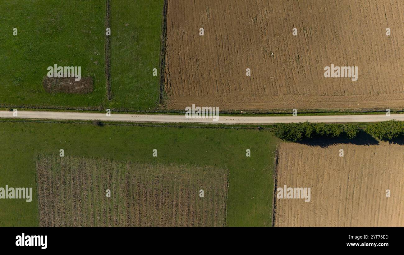 Aerial view of a straight road through rural farmland landscape, Bosnia ...