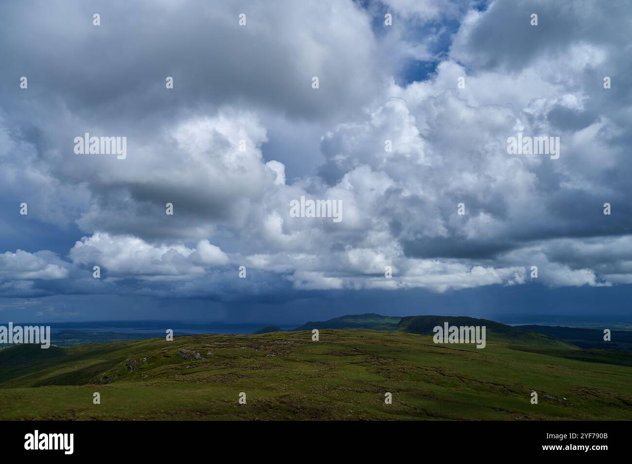 Cumulus or cluster clouds moving over a field with blue sky background ...
