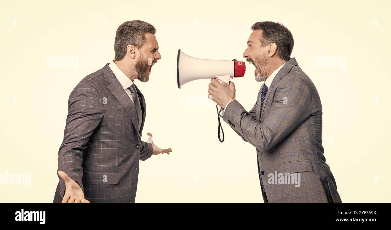 photo of two business men yell in megaphone. two business men yell in ...