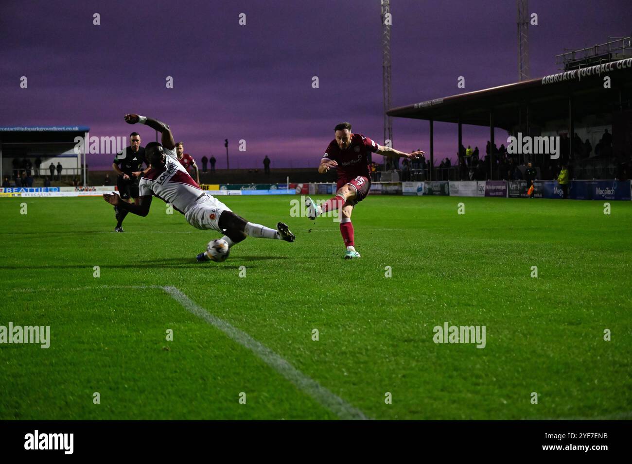 Football under a purple sky and floodlights at Gayfield, Arbroath, as ...