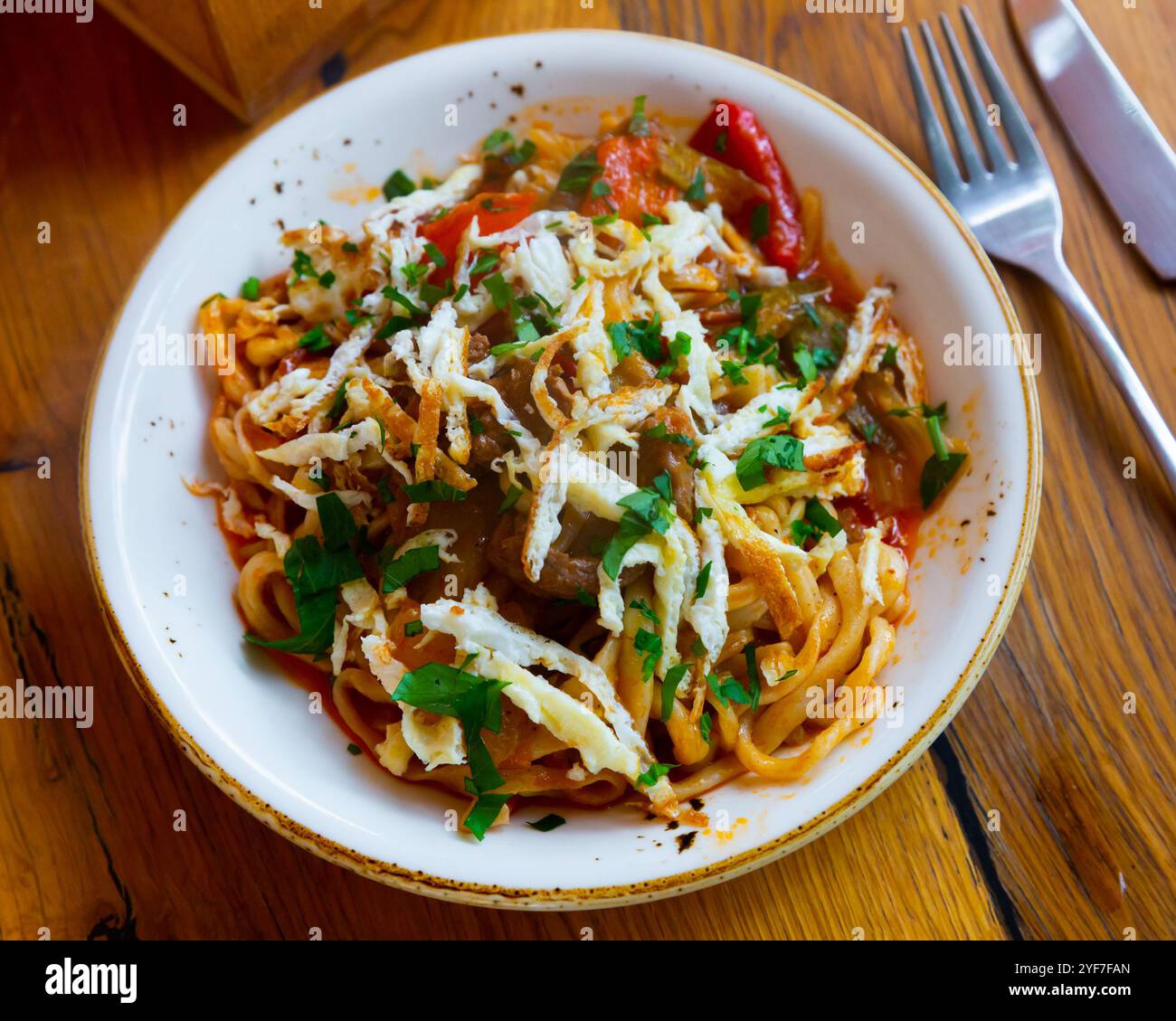 Traditional kaurma laghman noodles fried with vegetables, lamb and ...