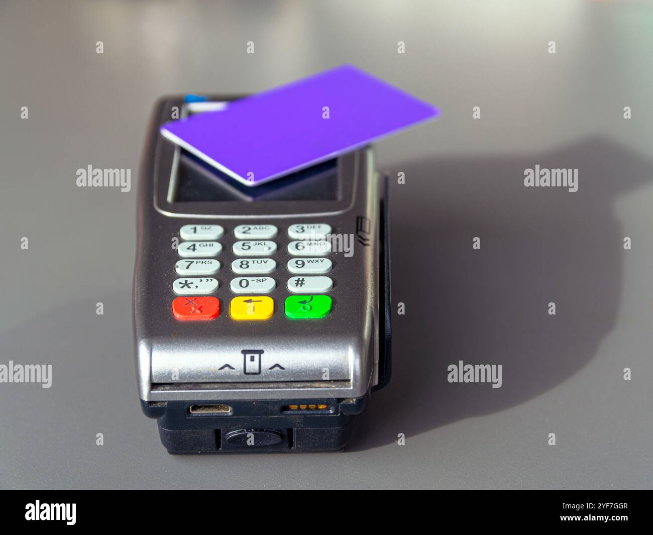 Payment terminal with purple card, contactless transaction Stock Photo ...