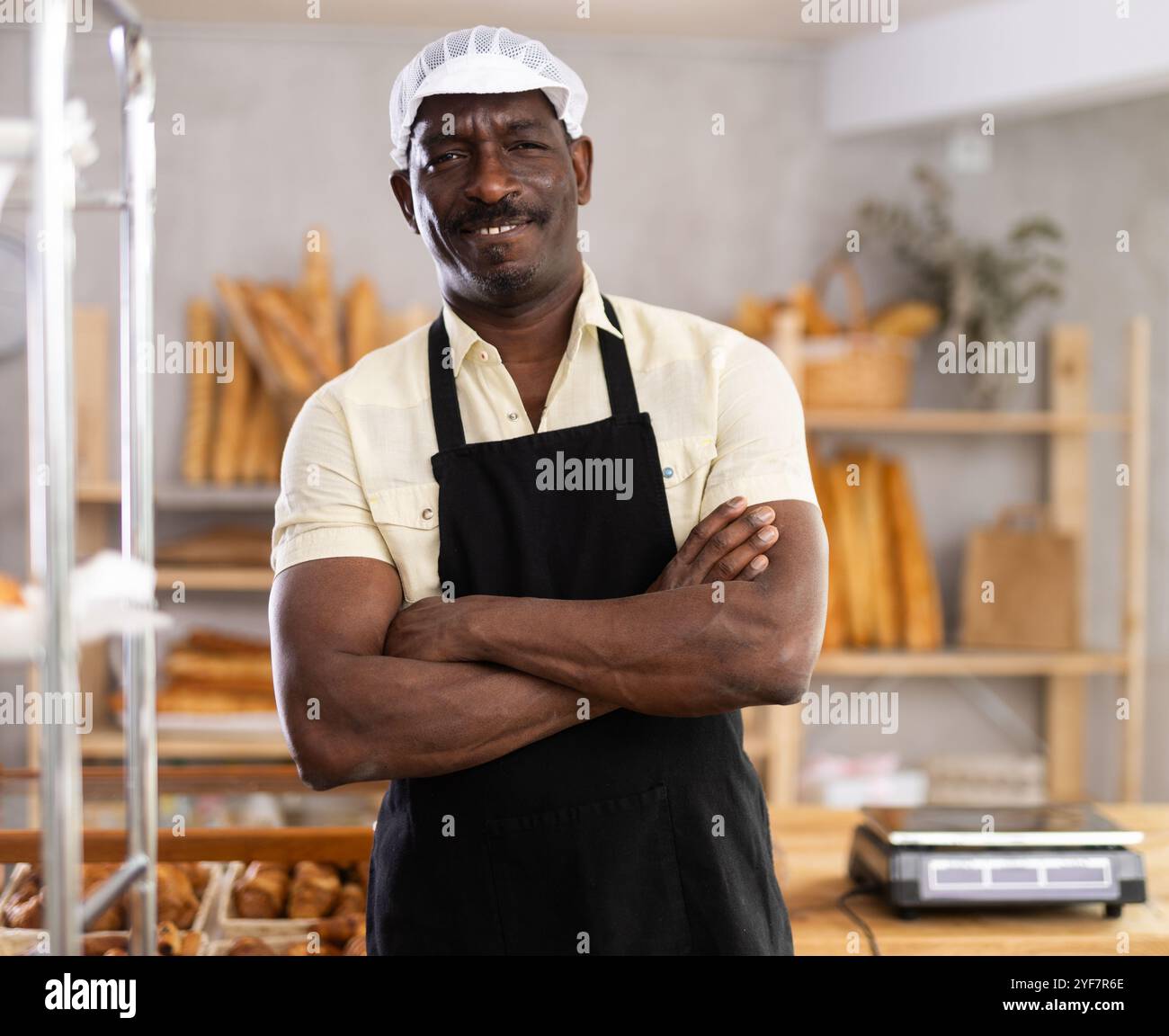 Portrait of positive man baker Stock Photo - Alamy