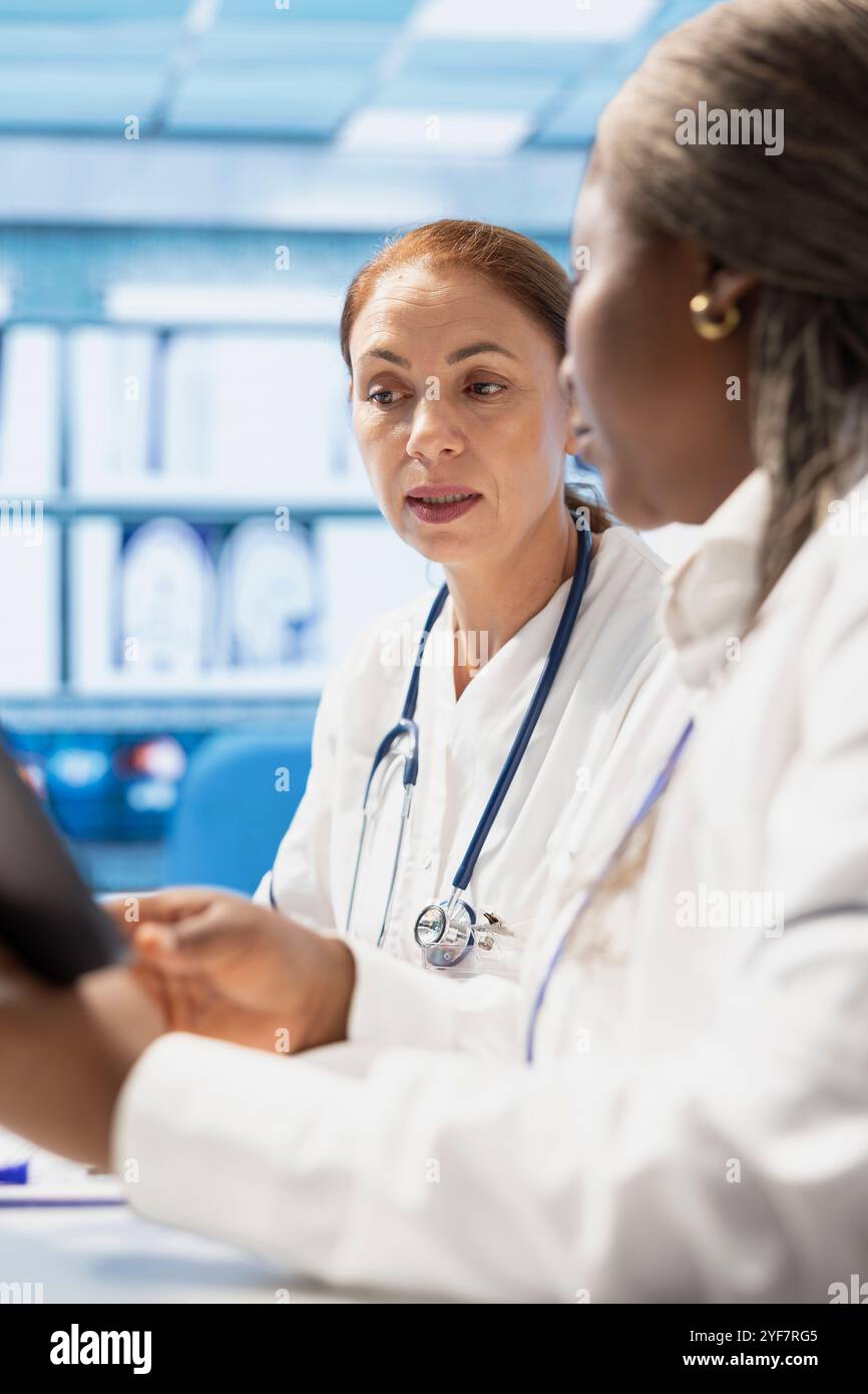 Diverse doctors team examining x ray scan results for effective ...