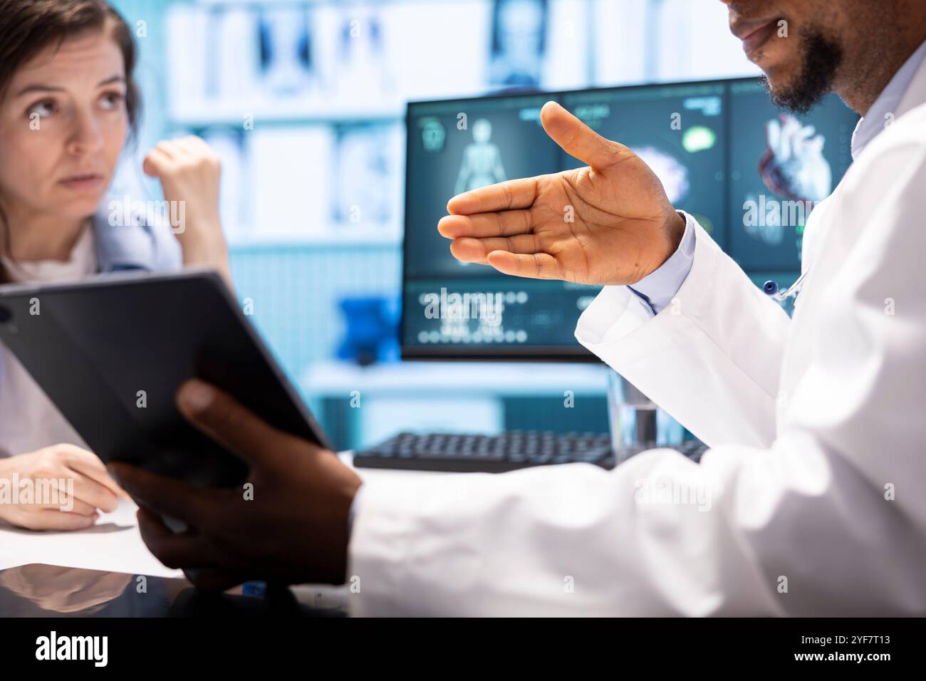 African american medic presenting the diagnostic reports to a female ...