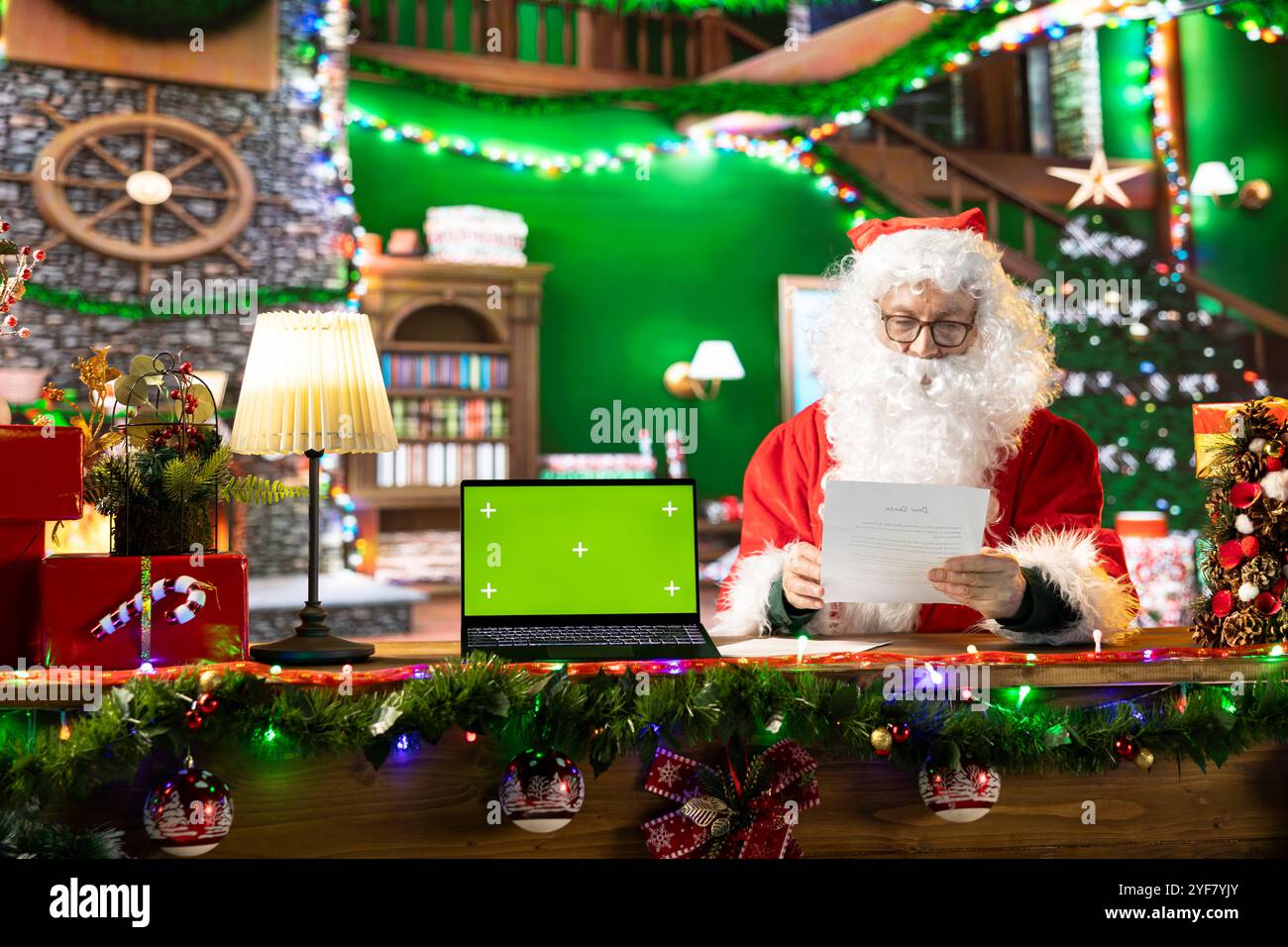 Father Christmas reading letters from children next to green screen ...