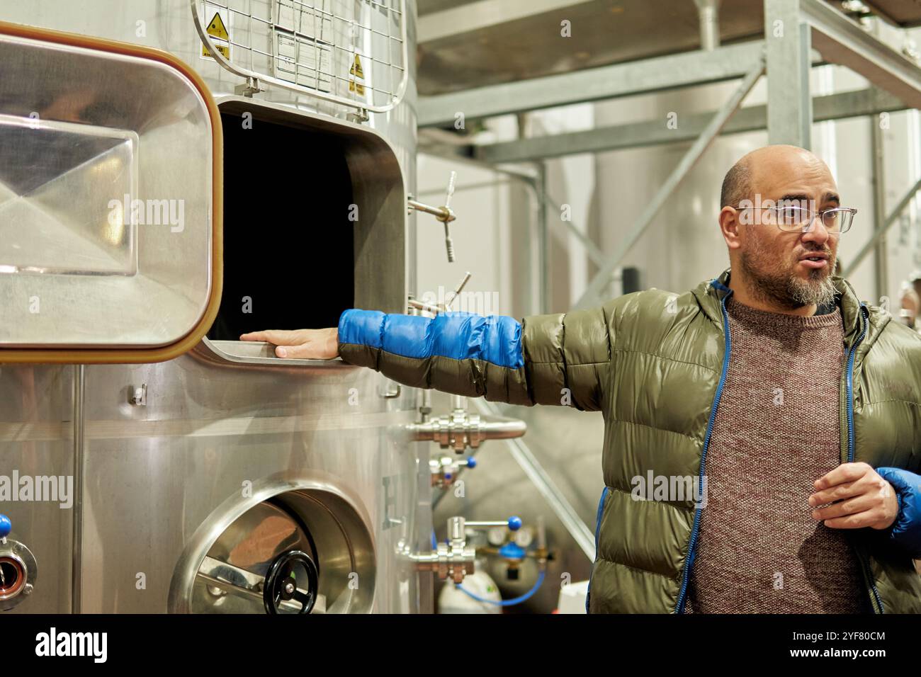 Beer factory owner showing the tanks and explaining the fermentation ...
