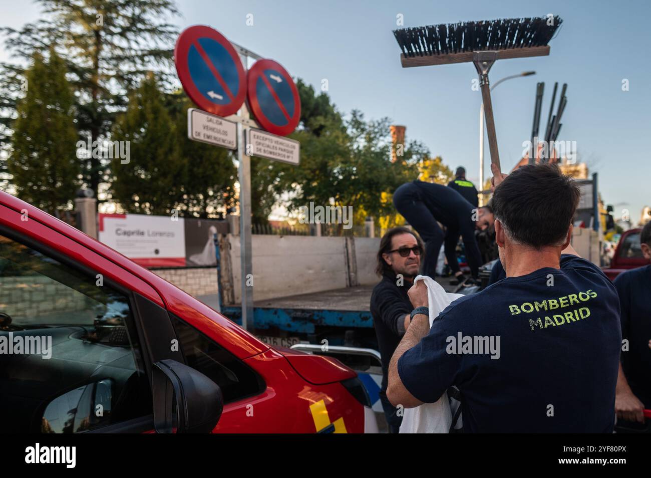 Firefighter organizing citizen donations of cleaning tools at a ...
