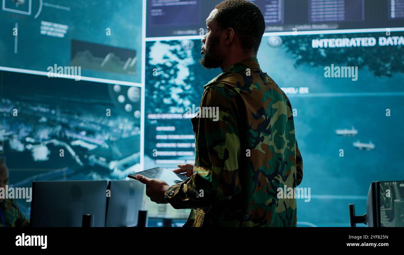 Cybersecurity specialist operates in a high tech military control ...