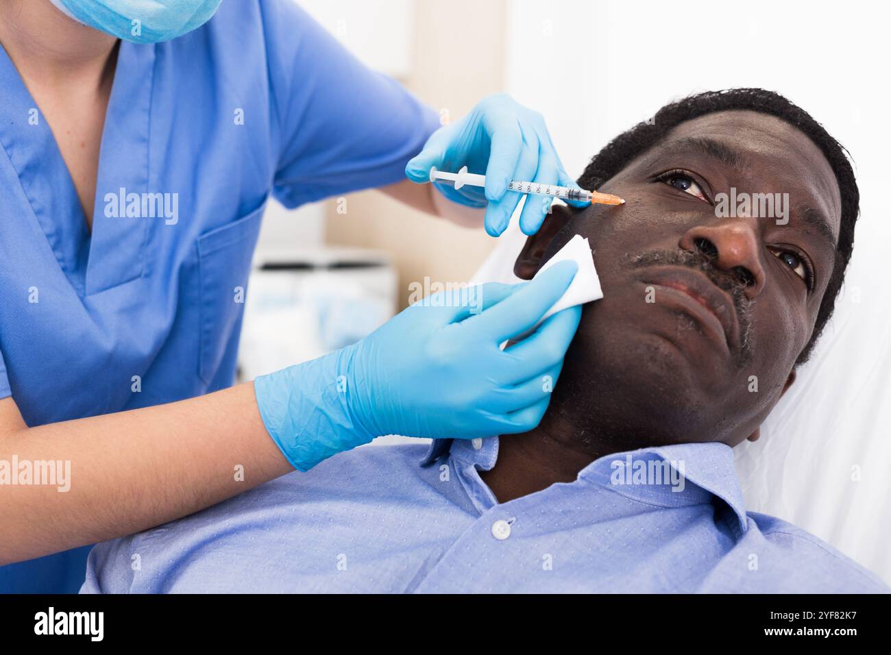 Man getting procedure of injection for face skin tightening Stock Photo ...