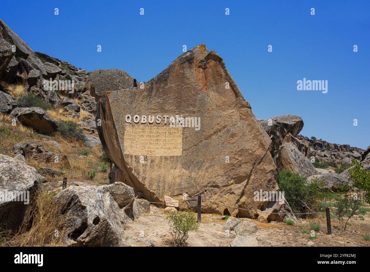 Commemorative plaque on a giant boulder at the entrance to the Gobustan ...