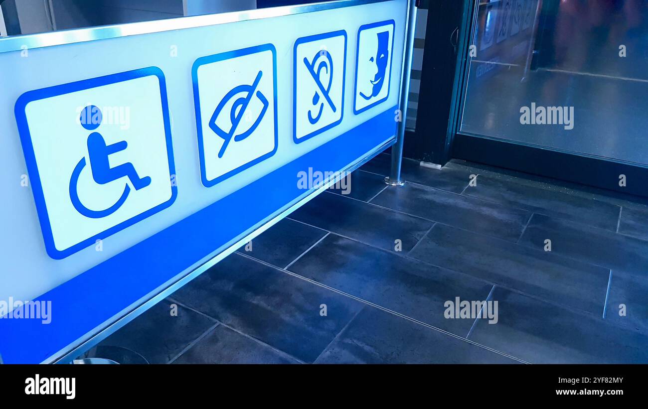 View of Blue panel with priority signage for people with disabilities ...