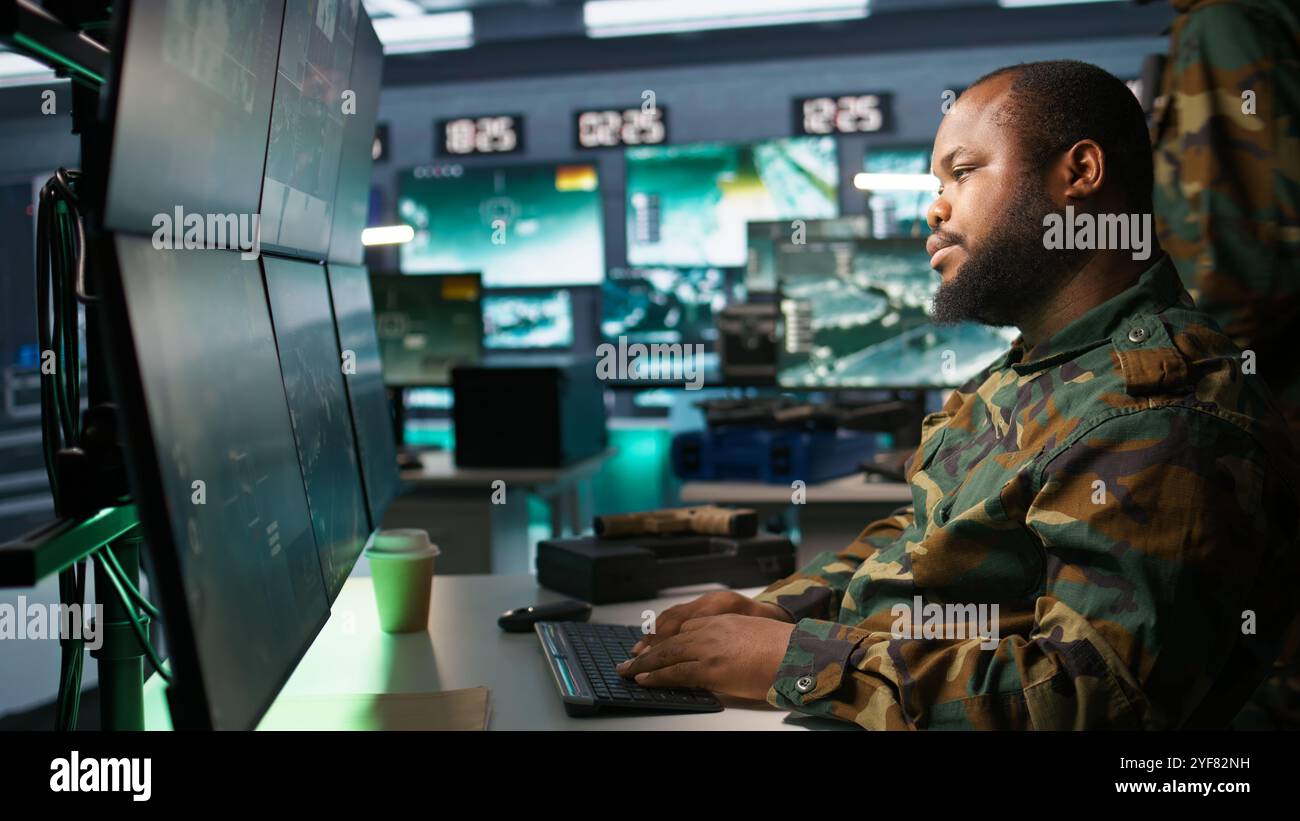 Military agent working overtime in control room to analyze aerial ...