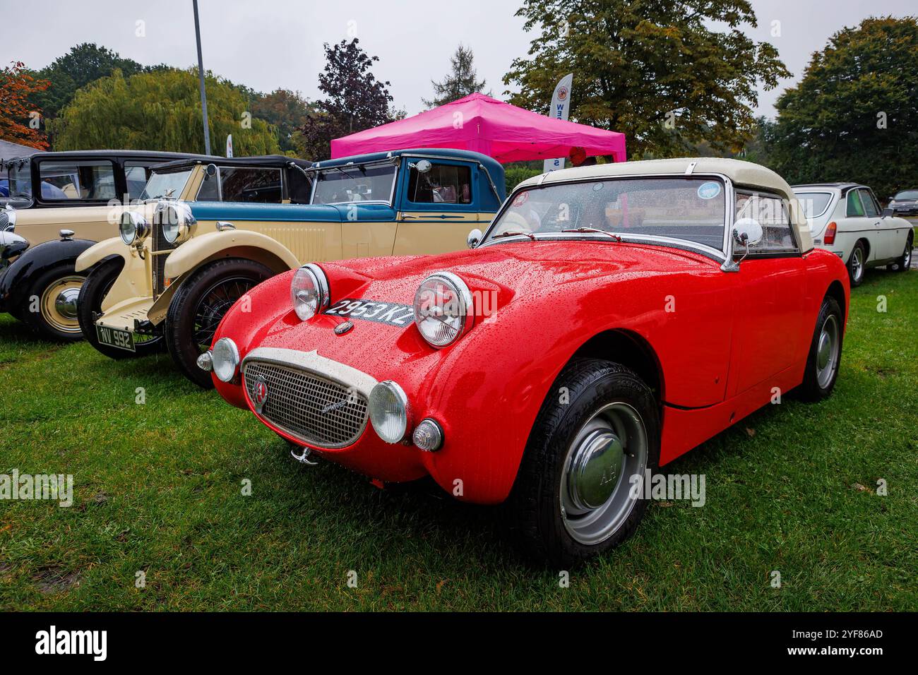 Red Austin Healey Sprite sports car on display at a classic car show in ...