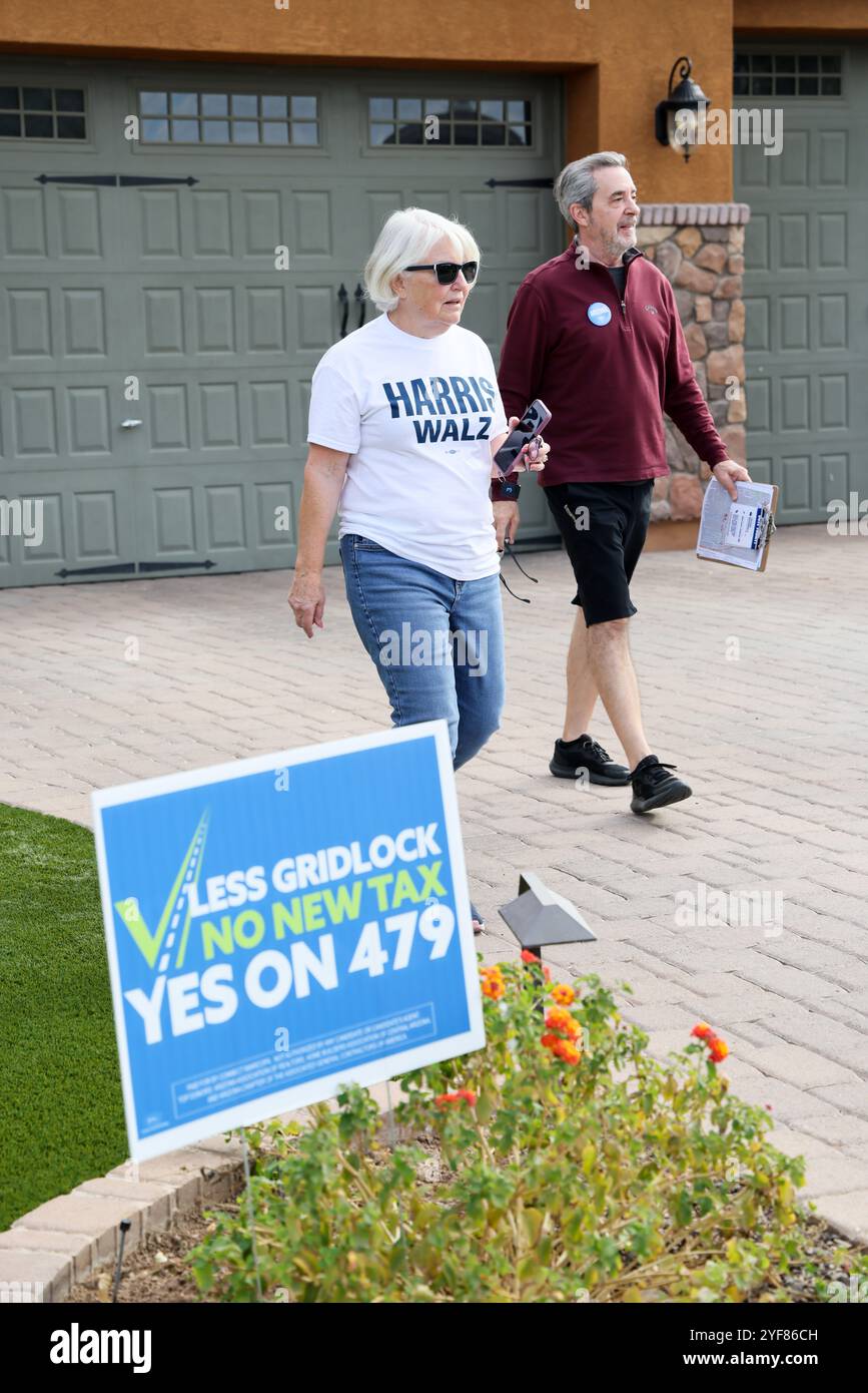 Mesa, USA. 03rd Nov, 2024. Volunteers Jessica and Kevin go door to door ...