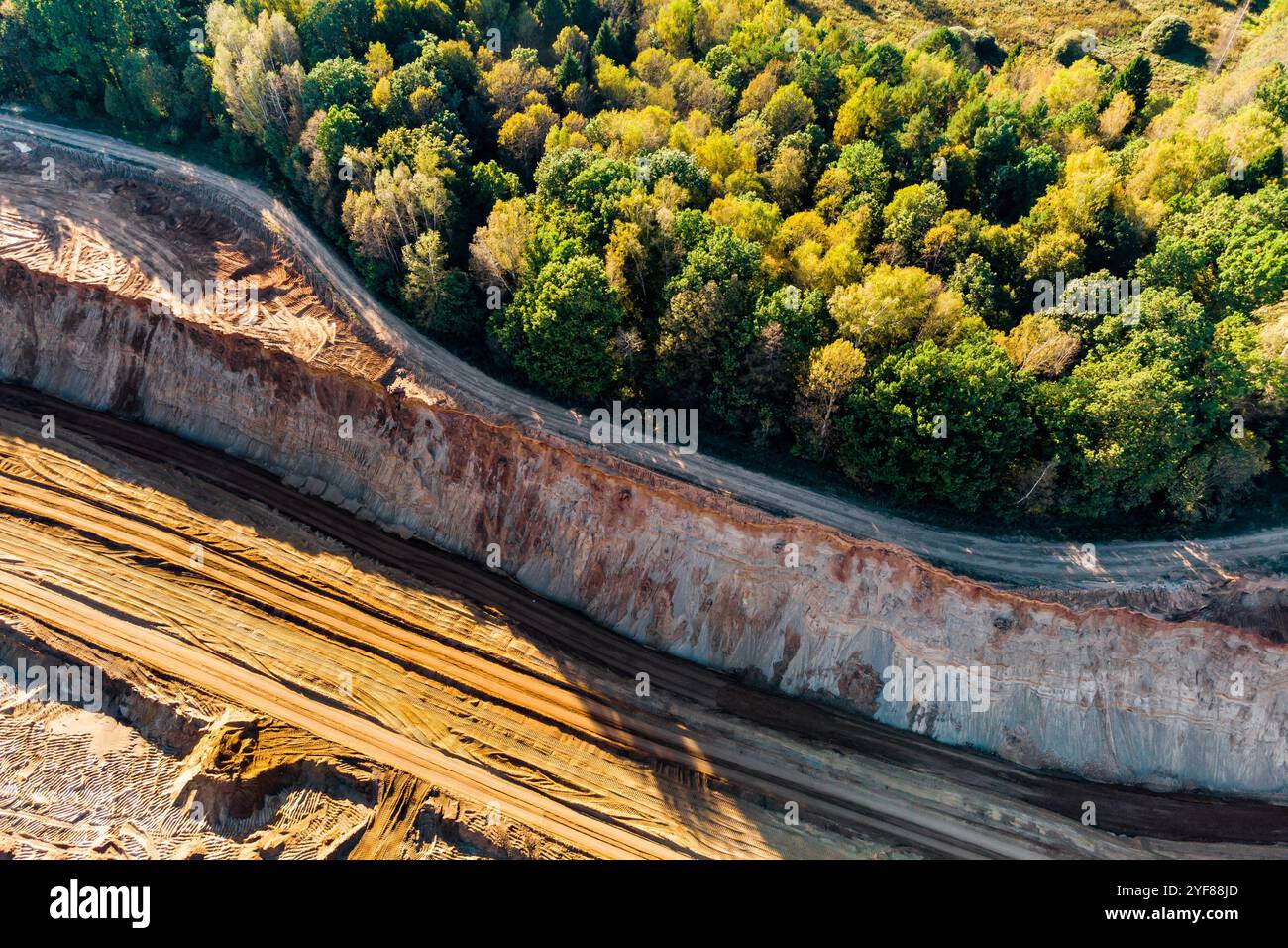 Aerial view of sand quarry edge near green forest Stock Photo - Alamy