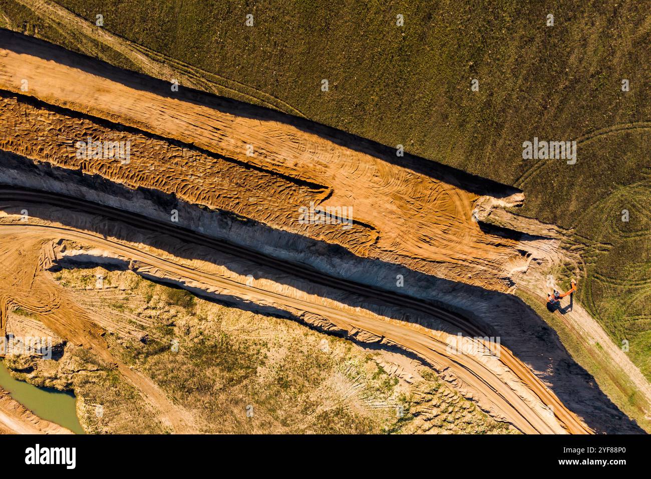 Excavator removing overburden for sand mining, aerial view Stock Photo ...