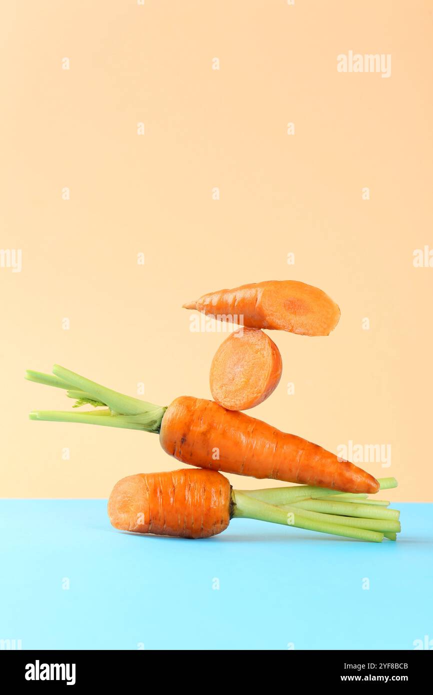 Whole and cut fresh carrots on color background Stock Photo - Alamy