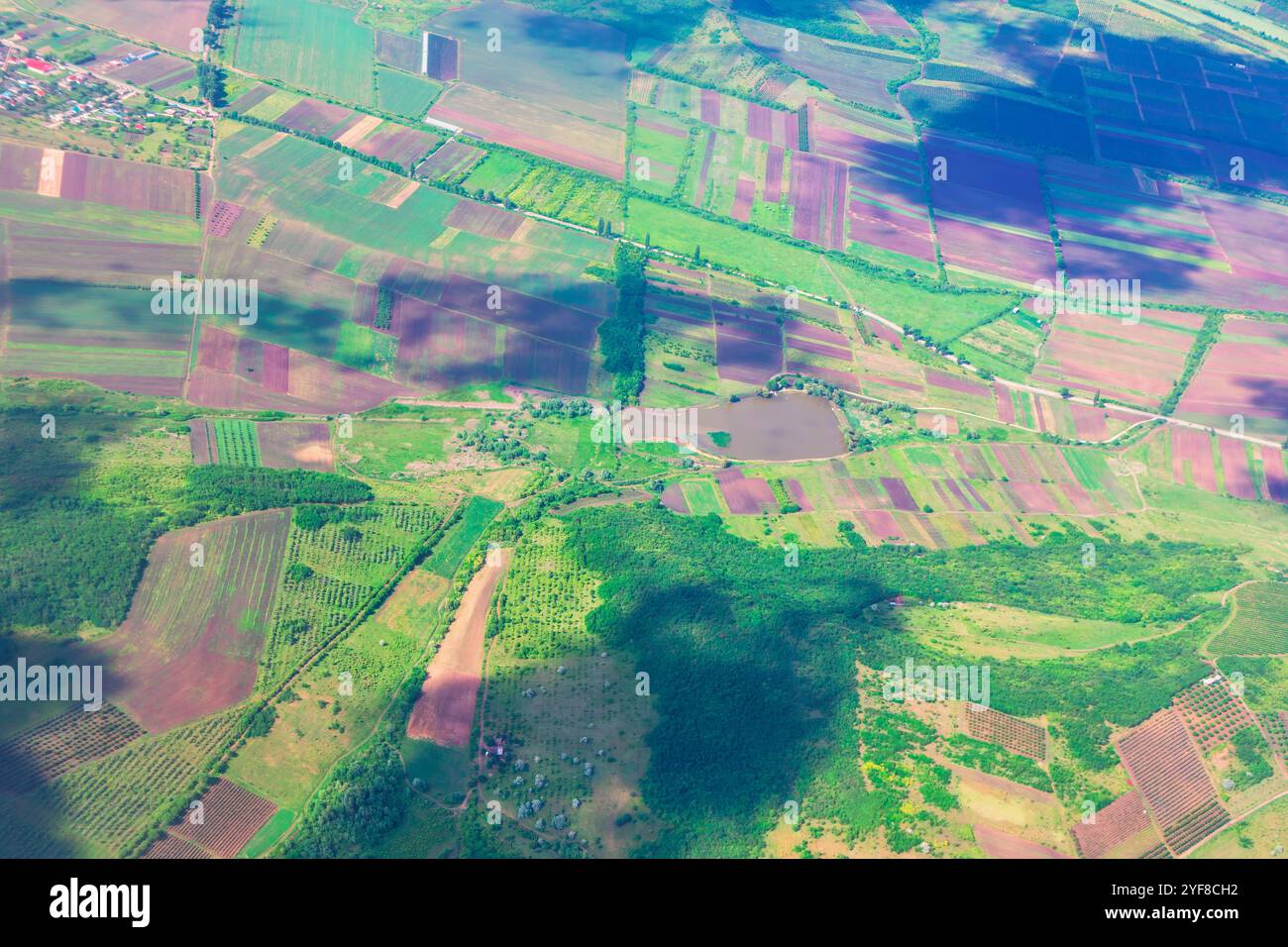 Airplane soaring above expansive farmland hi-res stock photography and ...