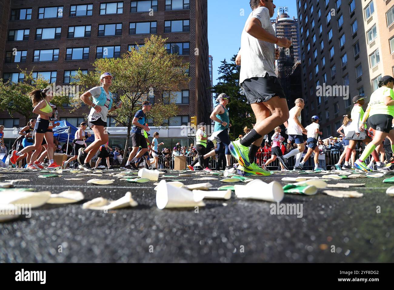 Runners step on used water cups discarded on the street during the 2024 ...