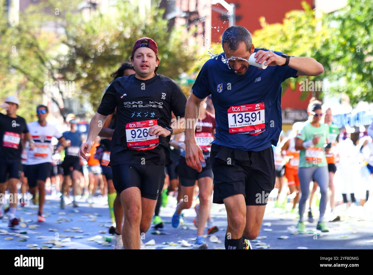A runner gets some needed relief after dousing himself with water while ...