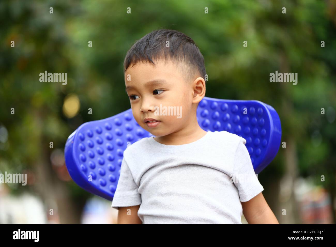 A joyful child enjoys playing outdoors in a park, showcasing a moment ...