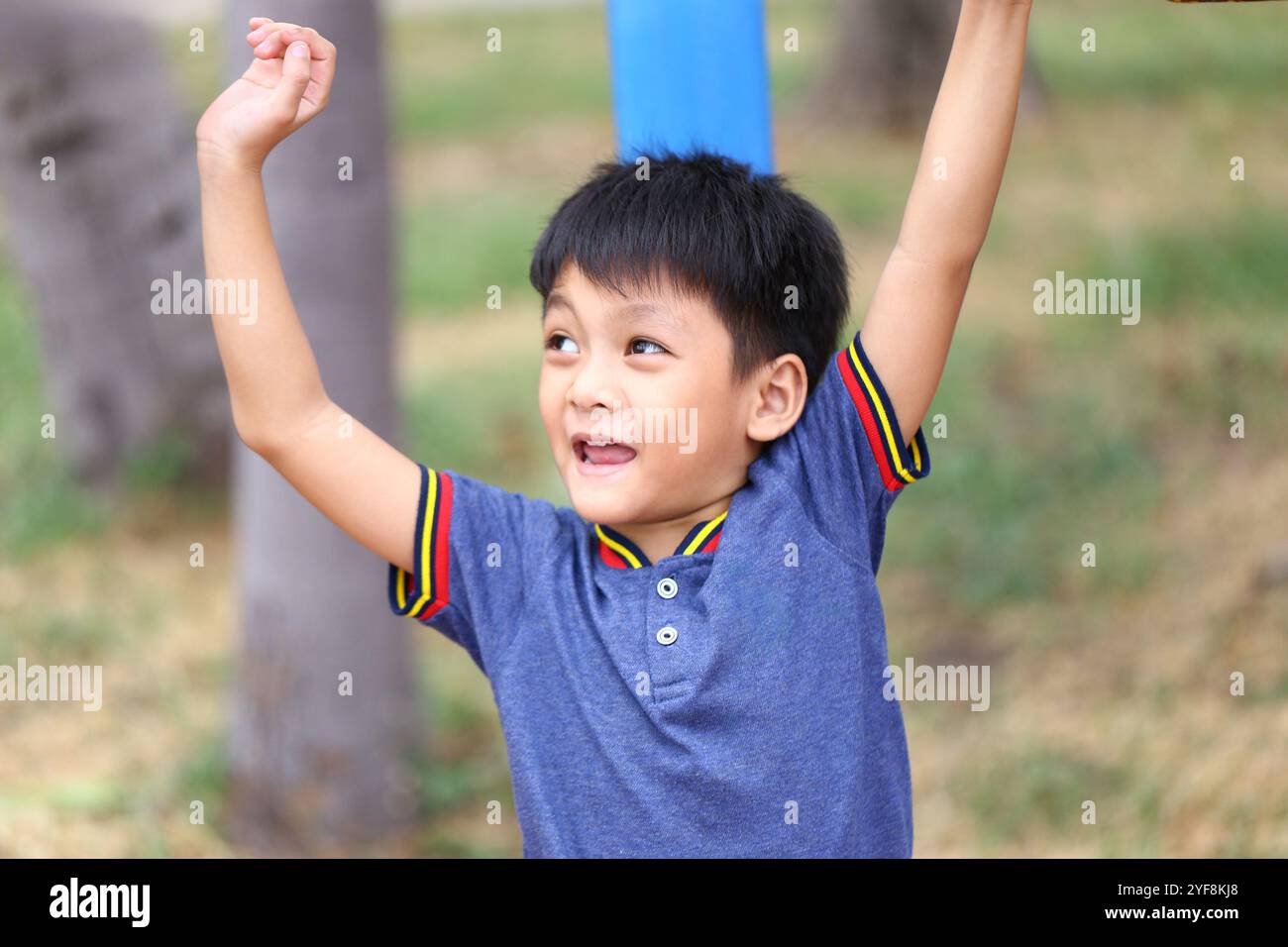 A joyful child enjoying playtime in a vibrant park. The scene captures ...