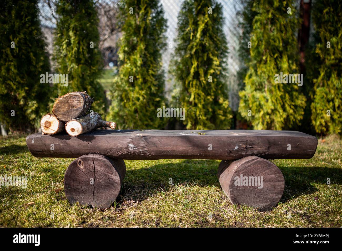 brown wooden log bench in yard Stock Photo - Alamy