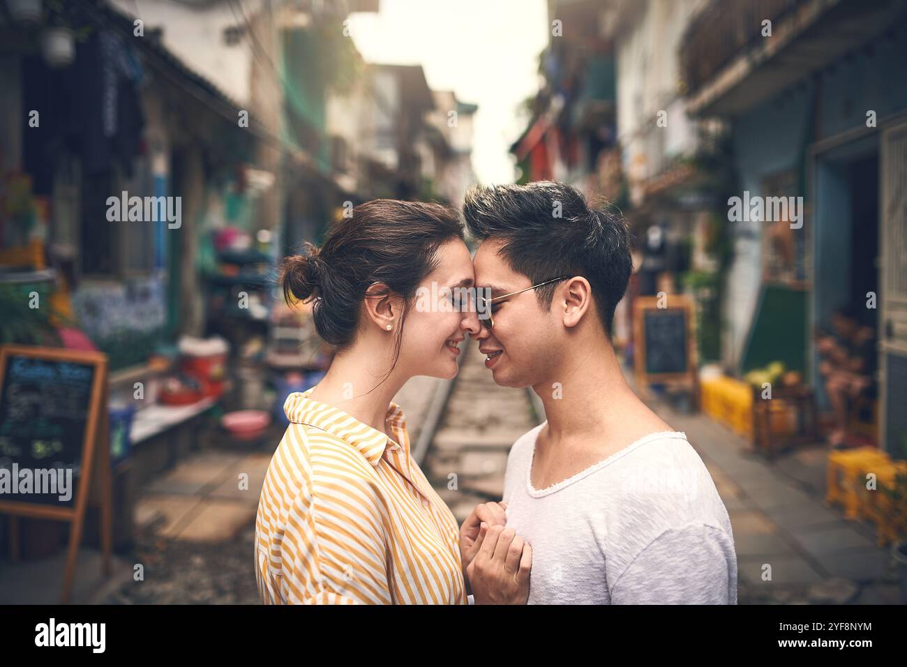 Happy, bonding and couple with forehead touch in city for vacation ...