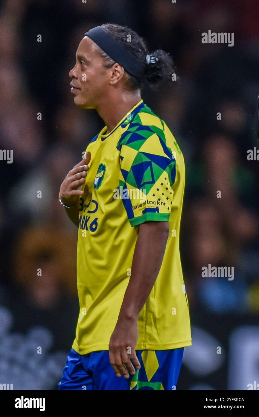 Ronaldinho of Ronaldinho's XI gestures to the fans as he is subbed off ...