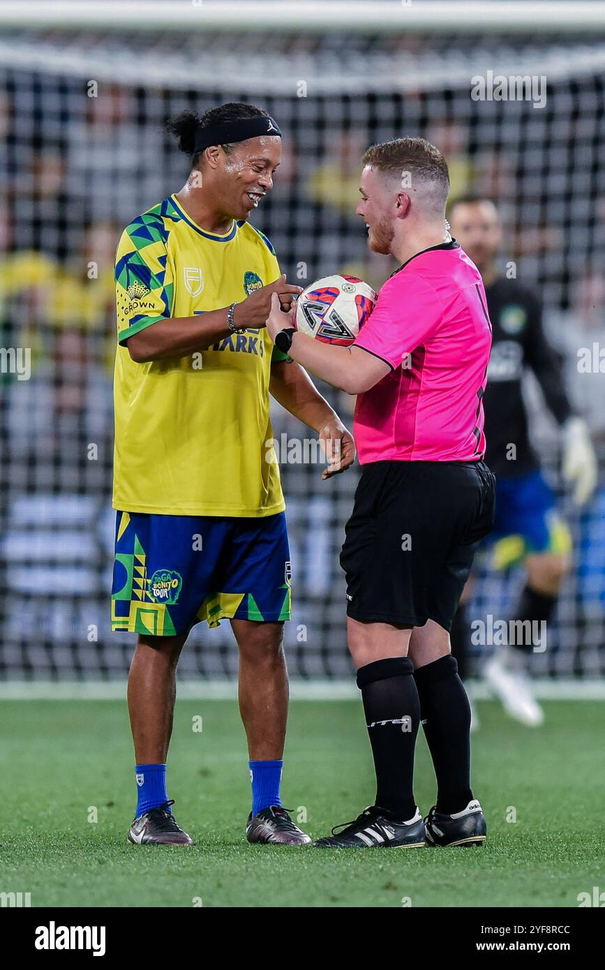 Ronaldinho of Ronaldinho's XI interacts with the referee as he is ...