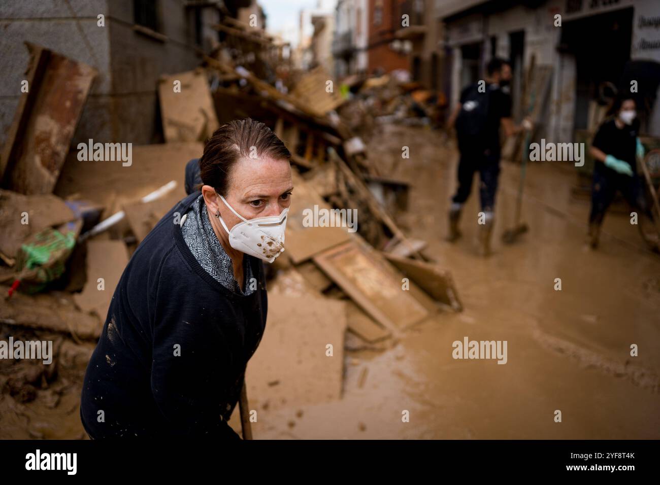 A woman is seen cleaning the streets of the city center. More than 200 ...