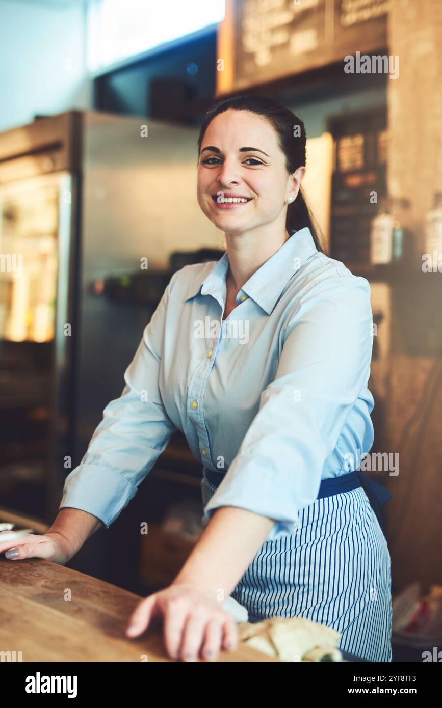 Woman, portrait and happy in cafe for hospitality, customer service and ...