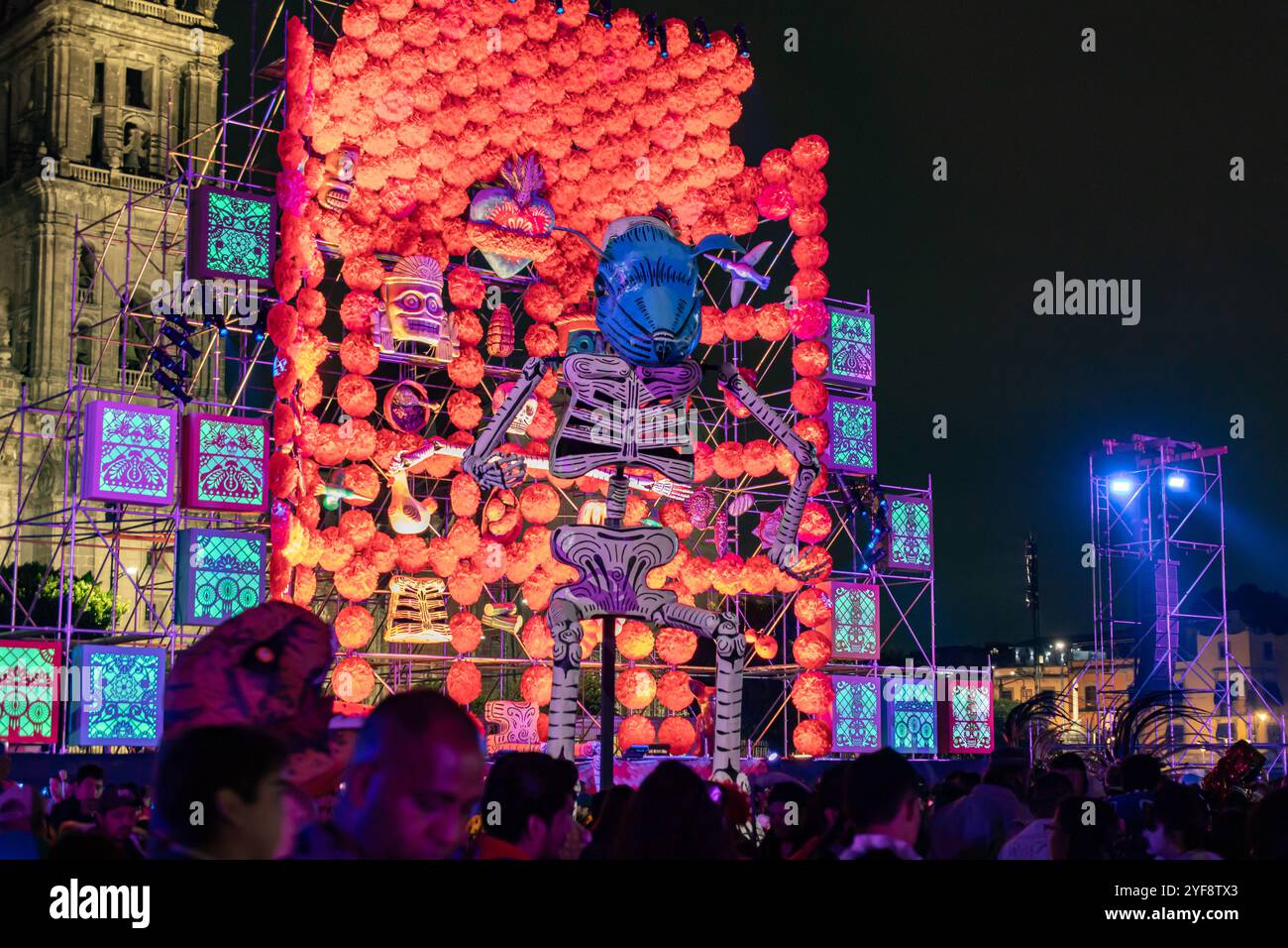 A vibrant Day of the Dead altar with illuminated decorations and ...