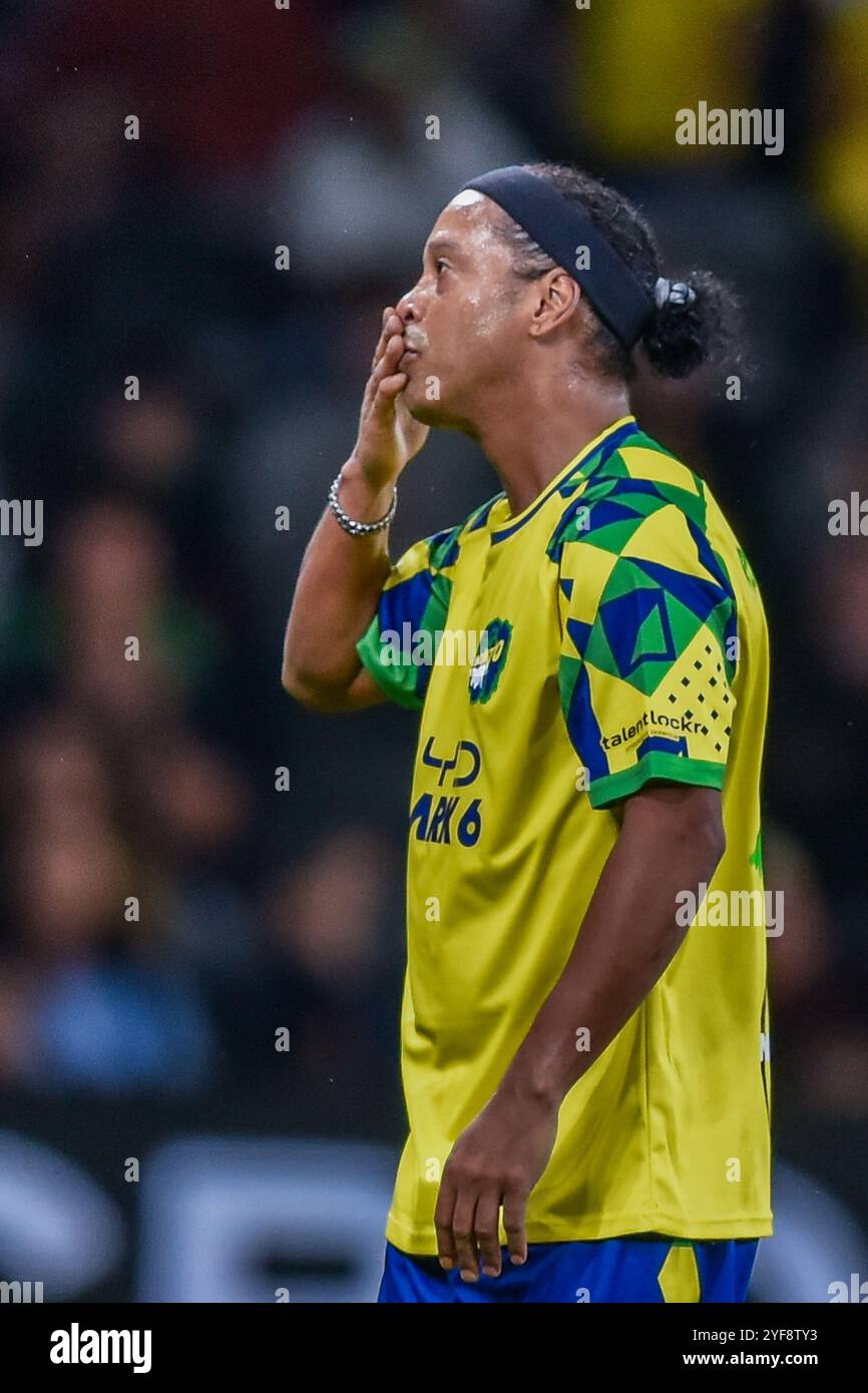 Ronaldinho of Ronaldinho's XI gestures to the fans as he is subbed off ...