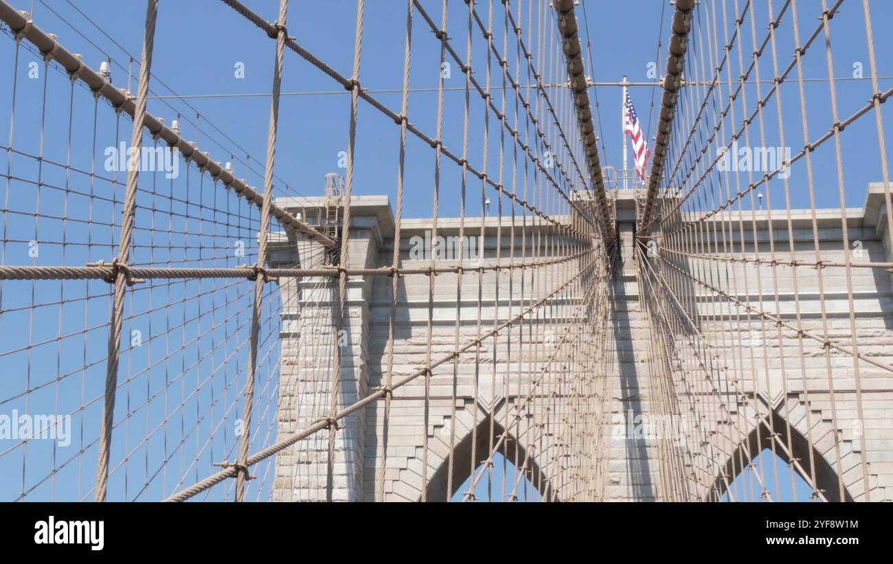 Brooklyn Bridge to Manhattan downtown, cables and blue sky. New York ...